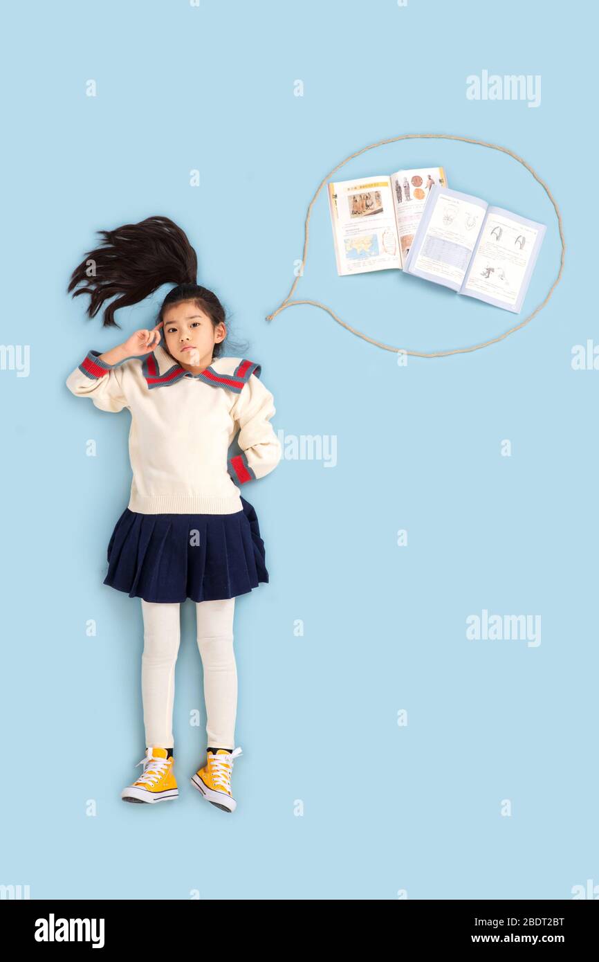 The little girl thinking about learning Stock Photo - Alamy