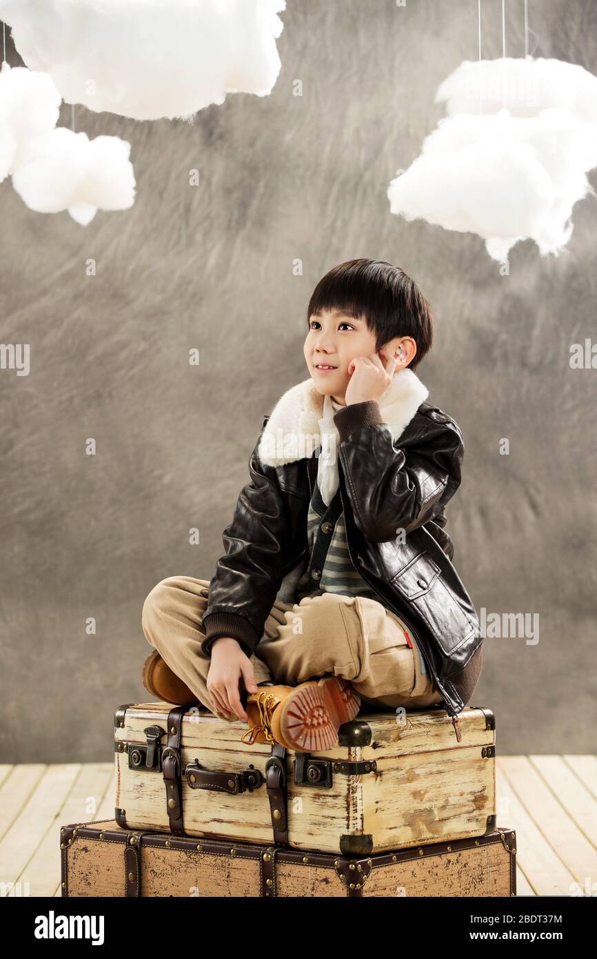 The little boy sat on the trunk Stock Photo - Alamy