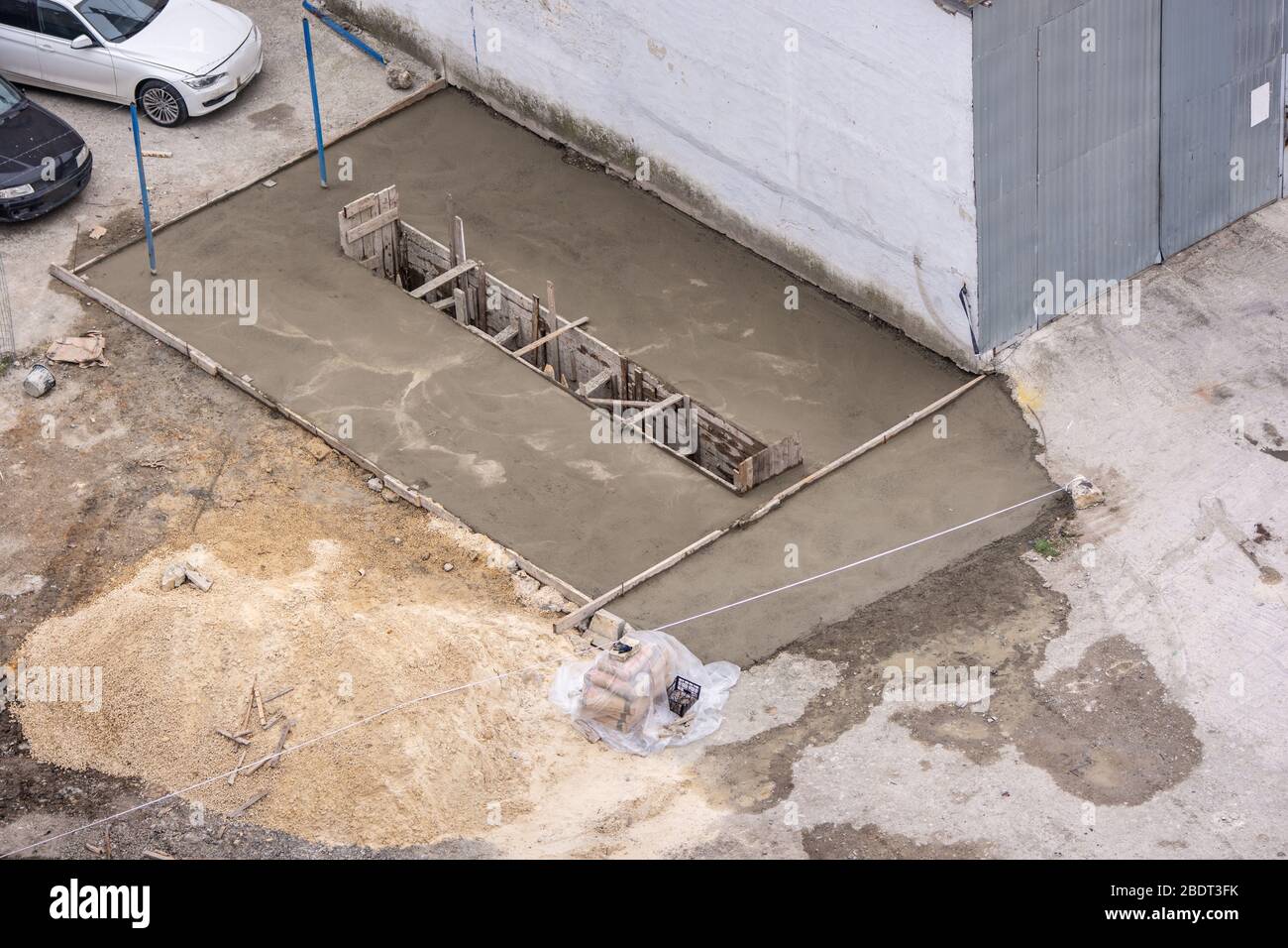 Inspection pit freshly concrete and fenced with formwork for machine ...