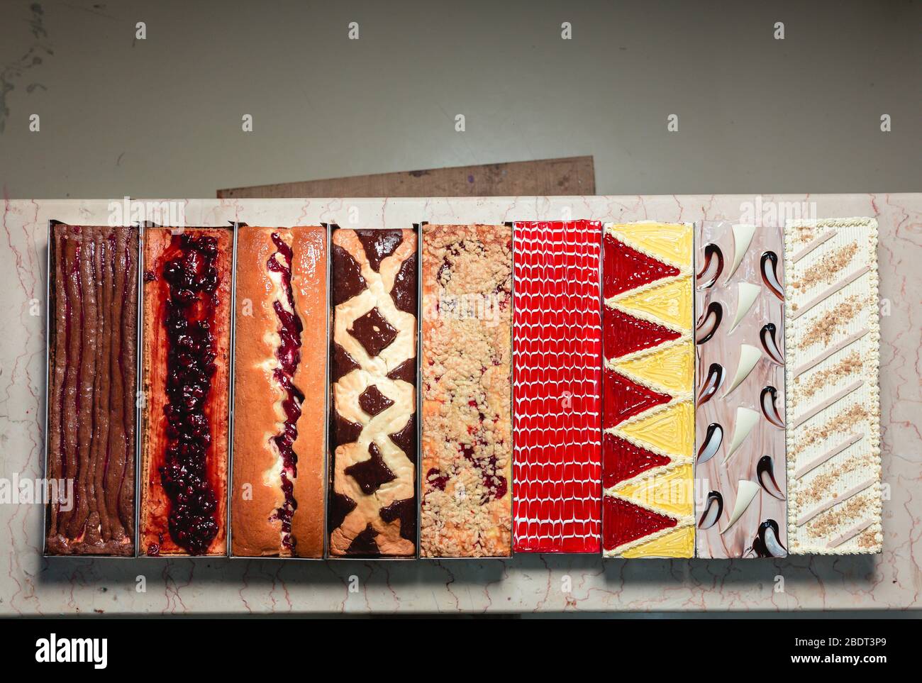 top view of nine portioned cake slices with different flavours Stock ...