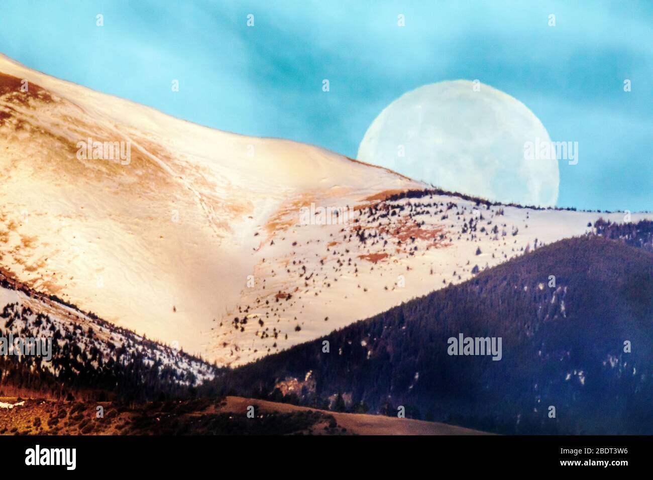 Full pink super moon setting over Rocky Mountains, Salida, Colorado ...