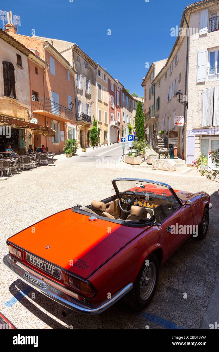 A vintage car (Triumph Spitfire MkIV) on the street in a commune in ...