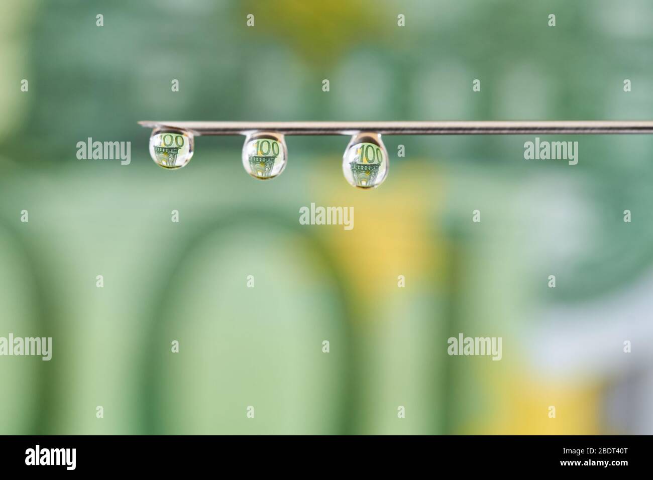 On the needle of the euro. ? drops flows from the syringe needle with ...