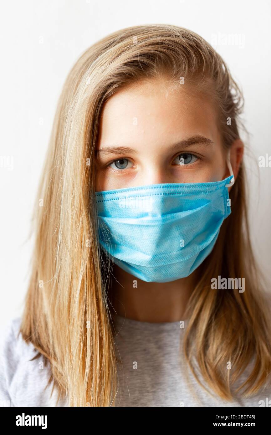 Little teenage girl in medical mask sad and scared. Coronavirus ...