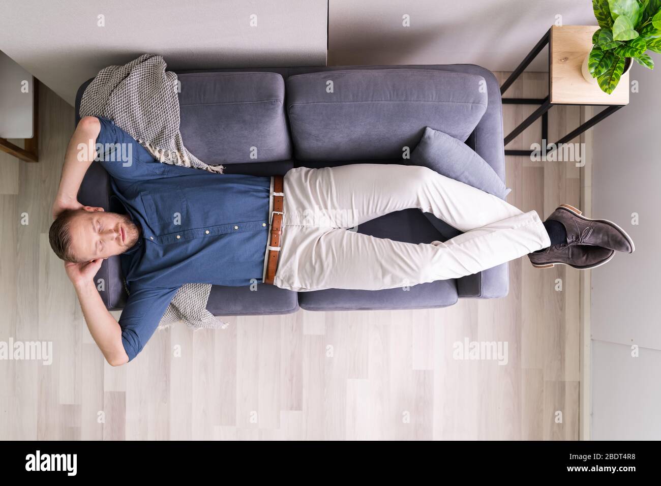 Portrait Of Tired Man Sleeping On Couch Stock Photo - Alamy
