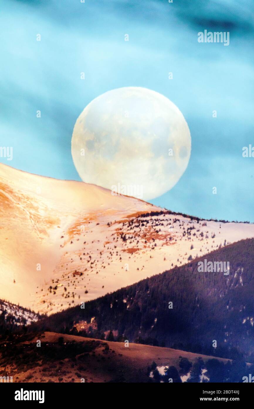 Full pink super moon setting over Rocky Mountains, Salida, Colorado ...