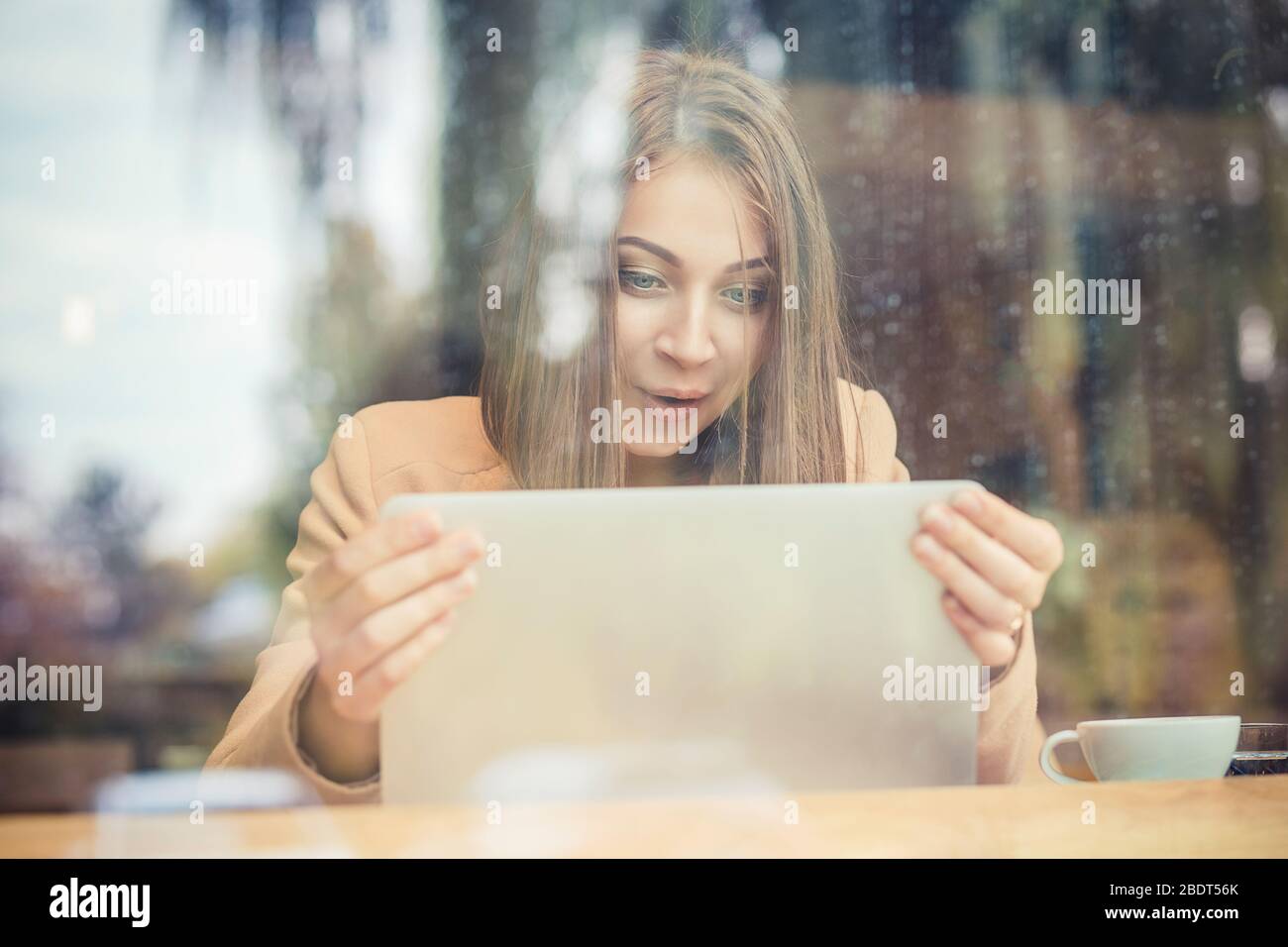 Excited surprised woman looking on computer laptop tablet screen in ...