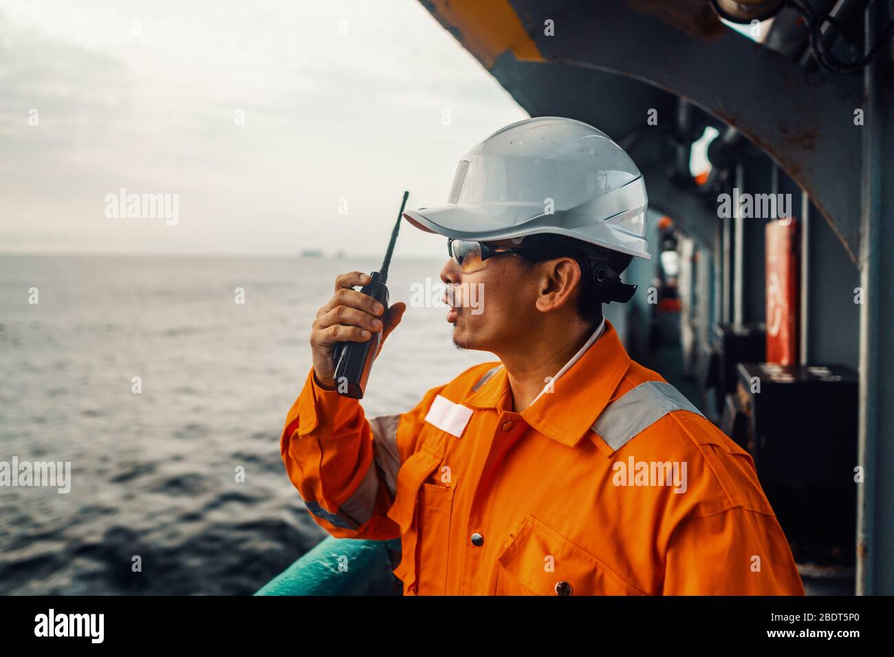 Filipino deck Officer on deck of vessel or ship , wearing PPE personal ...