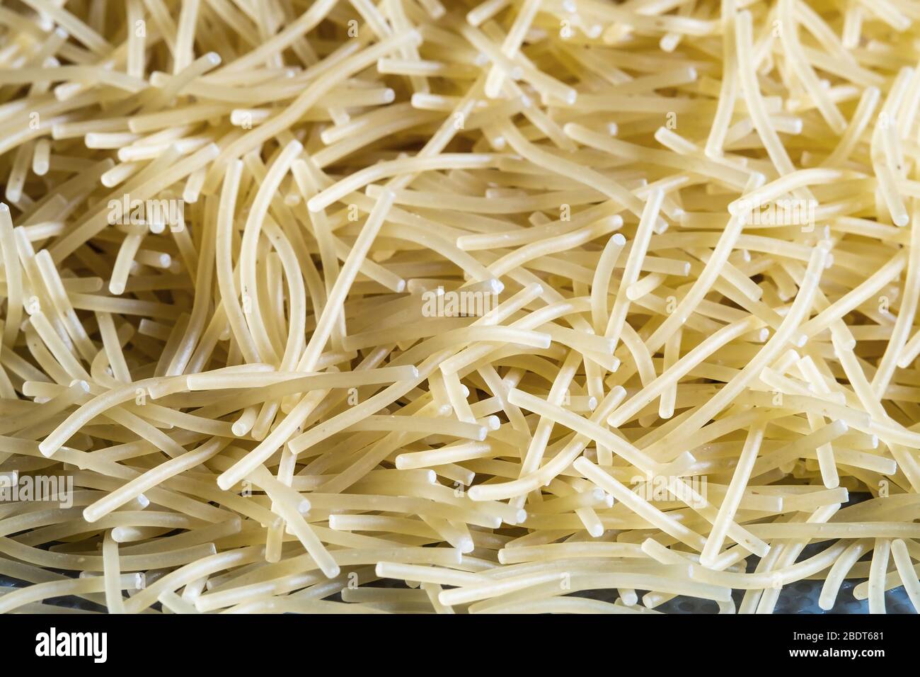 short thin vermicelli on the whole background. texture of dry yellow ...
