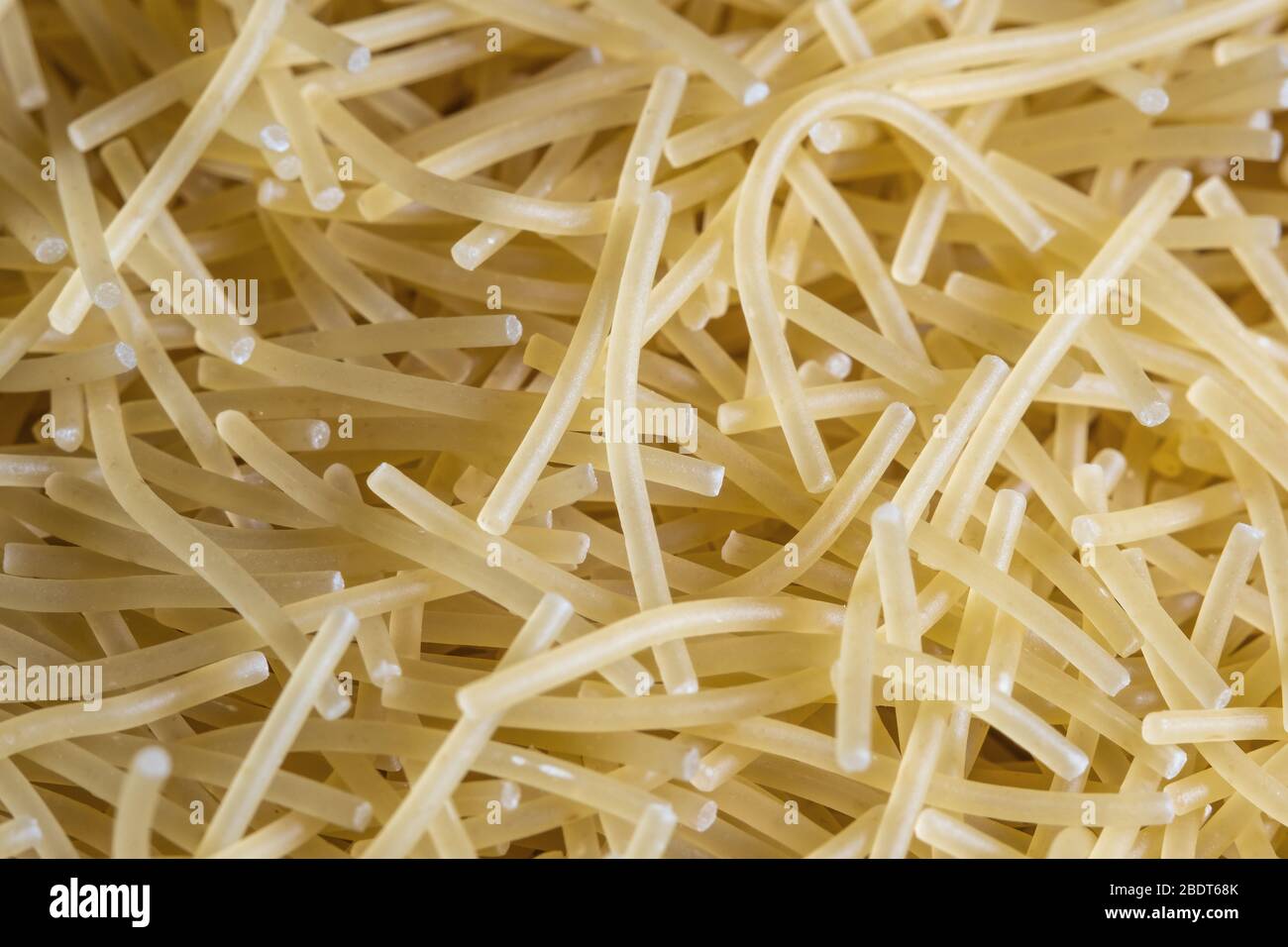 short thin vermicelli on the whole background. texture of dry yellow ...