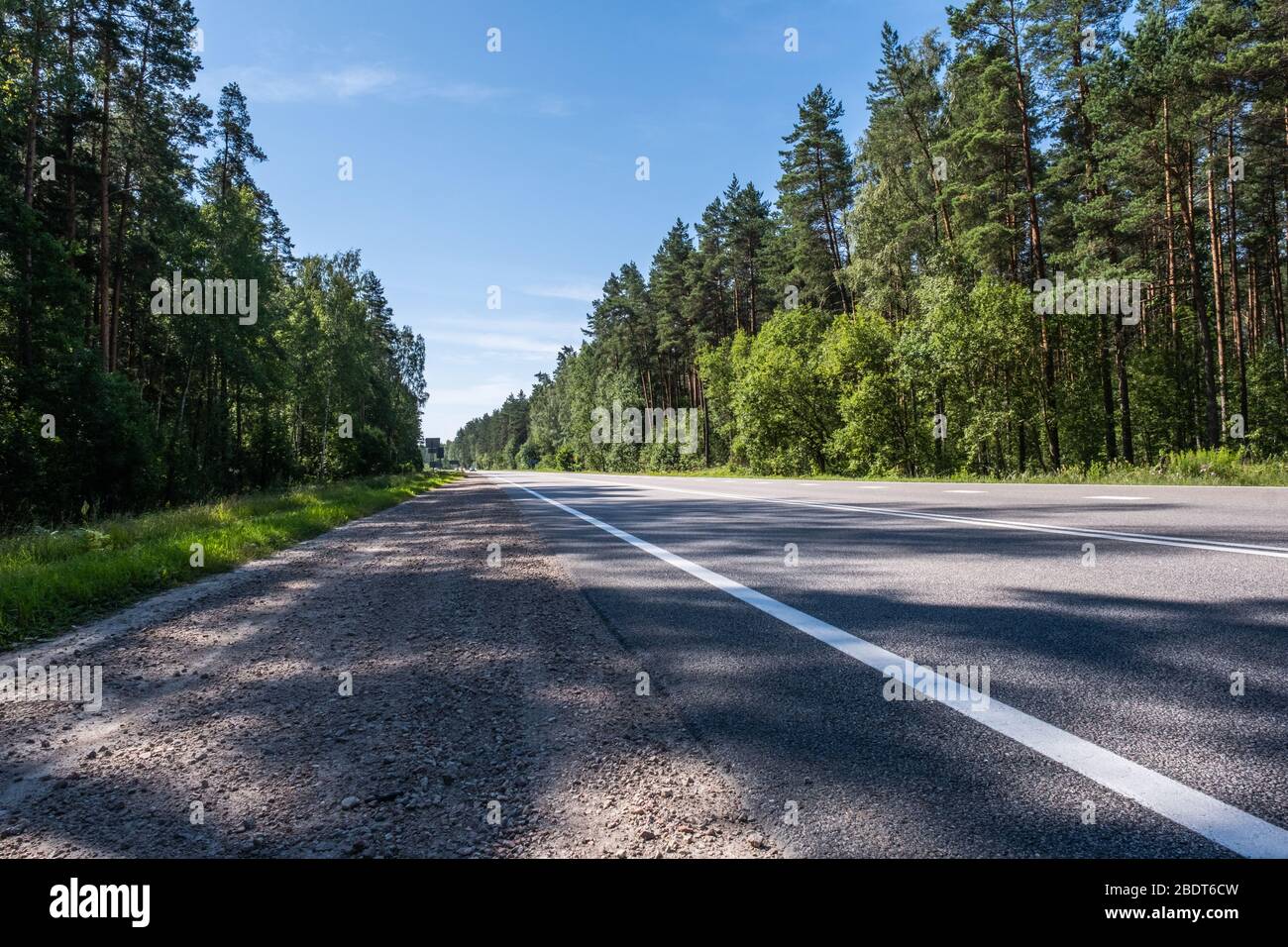 Empty highway, two lane road and the forest. asphalt road travel ...