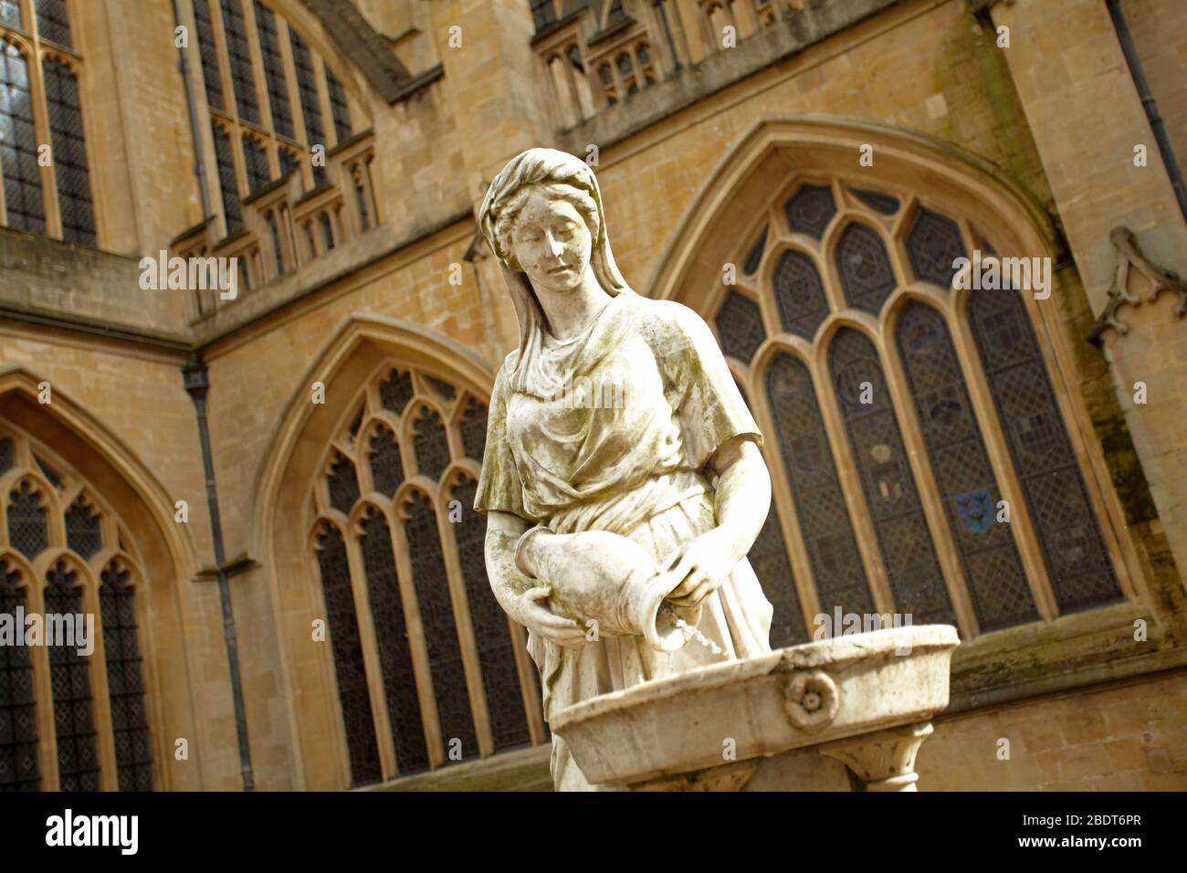 Statue of a woman pouring water outside Bath Abbey Stock Photo - Alamy