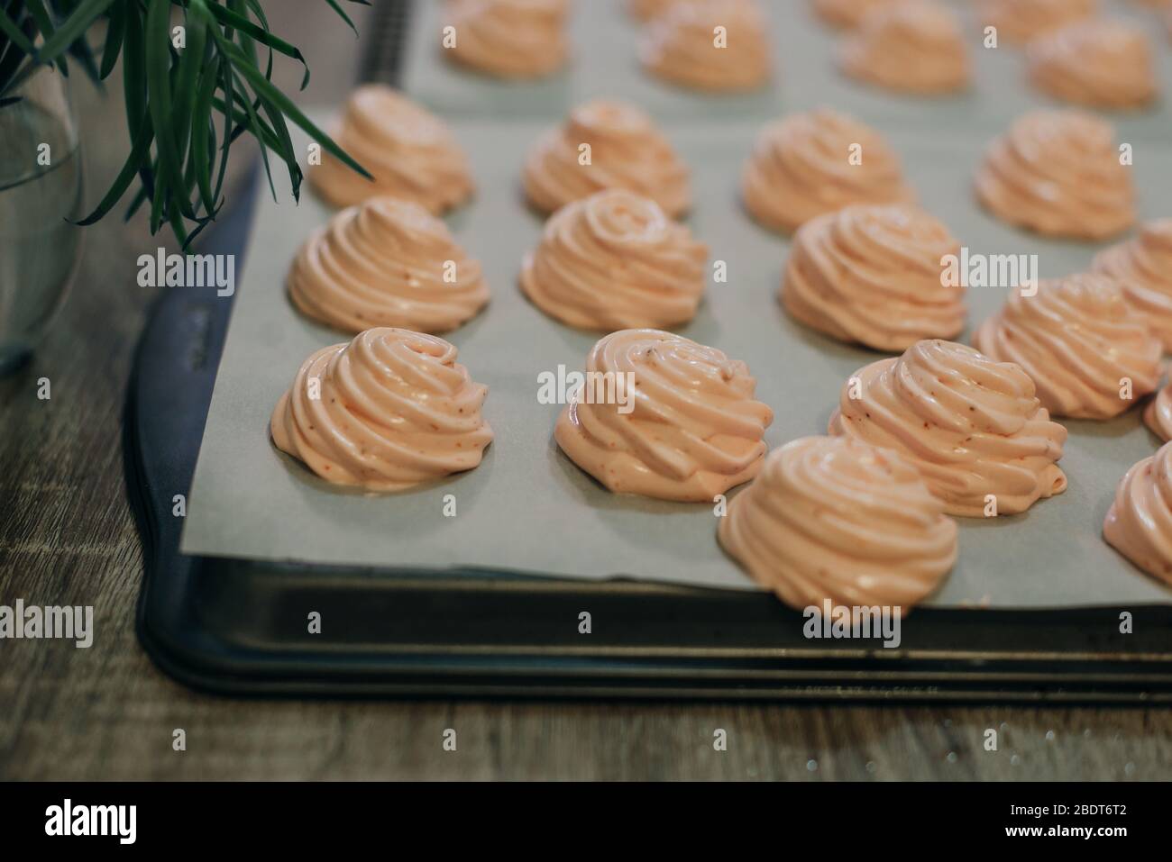 Homemade pink marshmallows on baking paper background on the kitchen ...