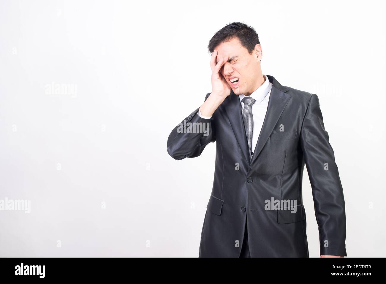 Sore man in suit. White background. middle plane Stock Photo - Alamy