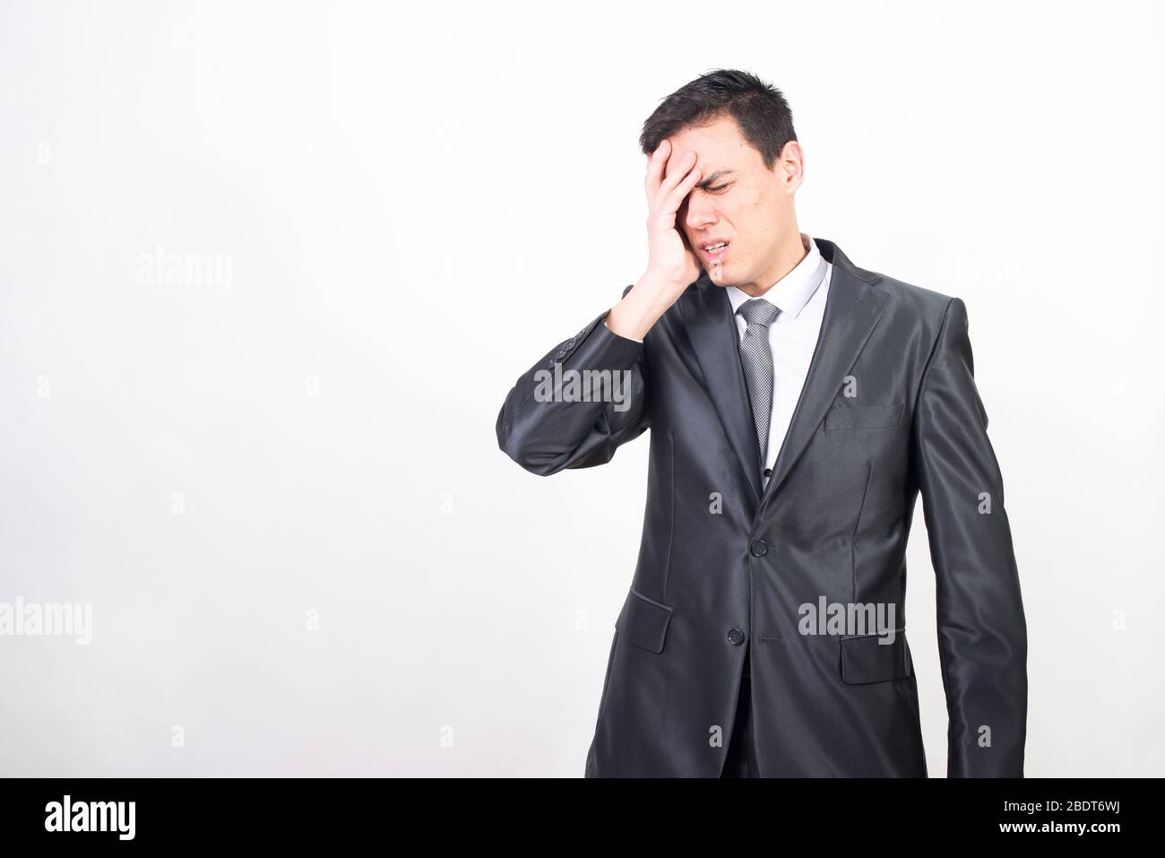 Sore man in suit. White background. middle plane Stock Photo - Alamy