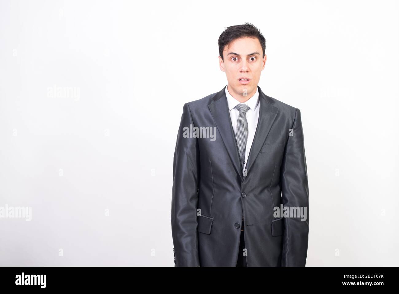 Man in suit in shock. white background, medium shot Stock Photo - Alamy