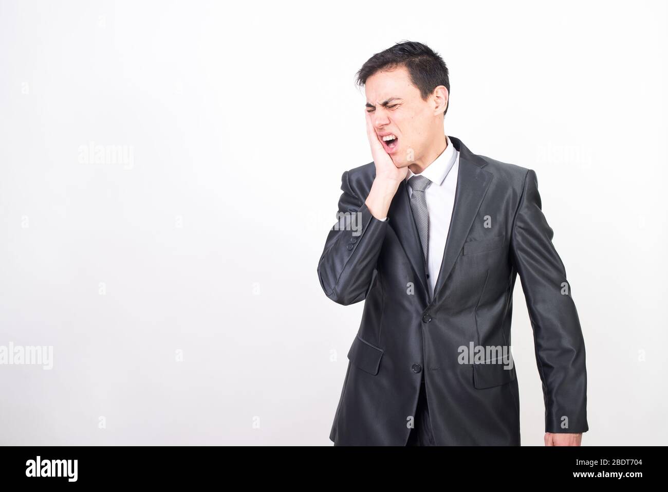 Sore man in suit. White background. middle plane Stock Photo - Alamy