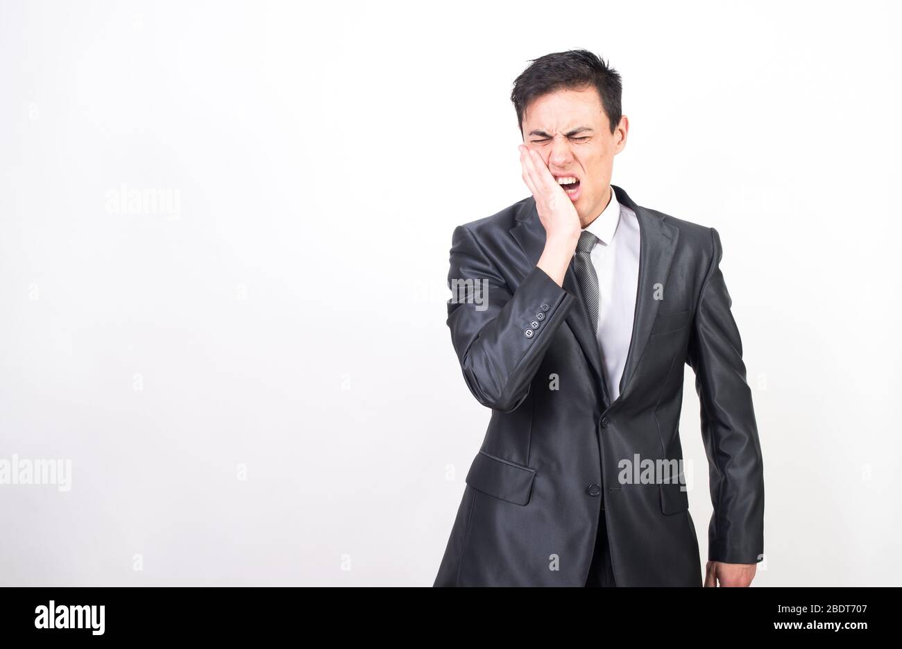Sore man in suit. White background. middle plane Stock Photo - Alamy
