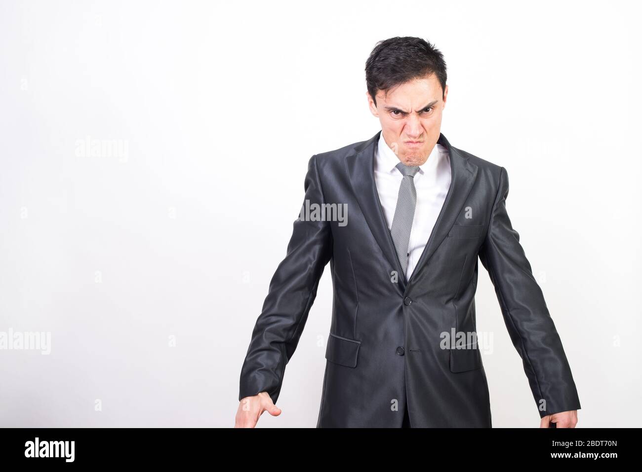 Angry man in suit. white background, medium shot Stock Photo - Alamy