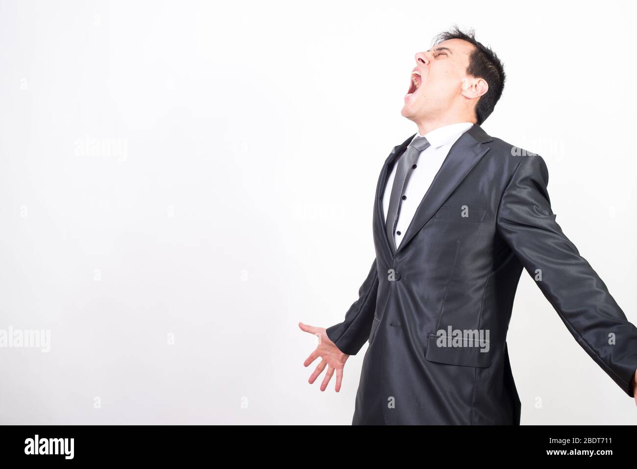 Screaming man in suit. white background, medium shot Stock Photo - Alamy