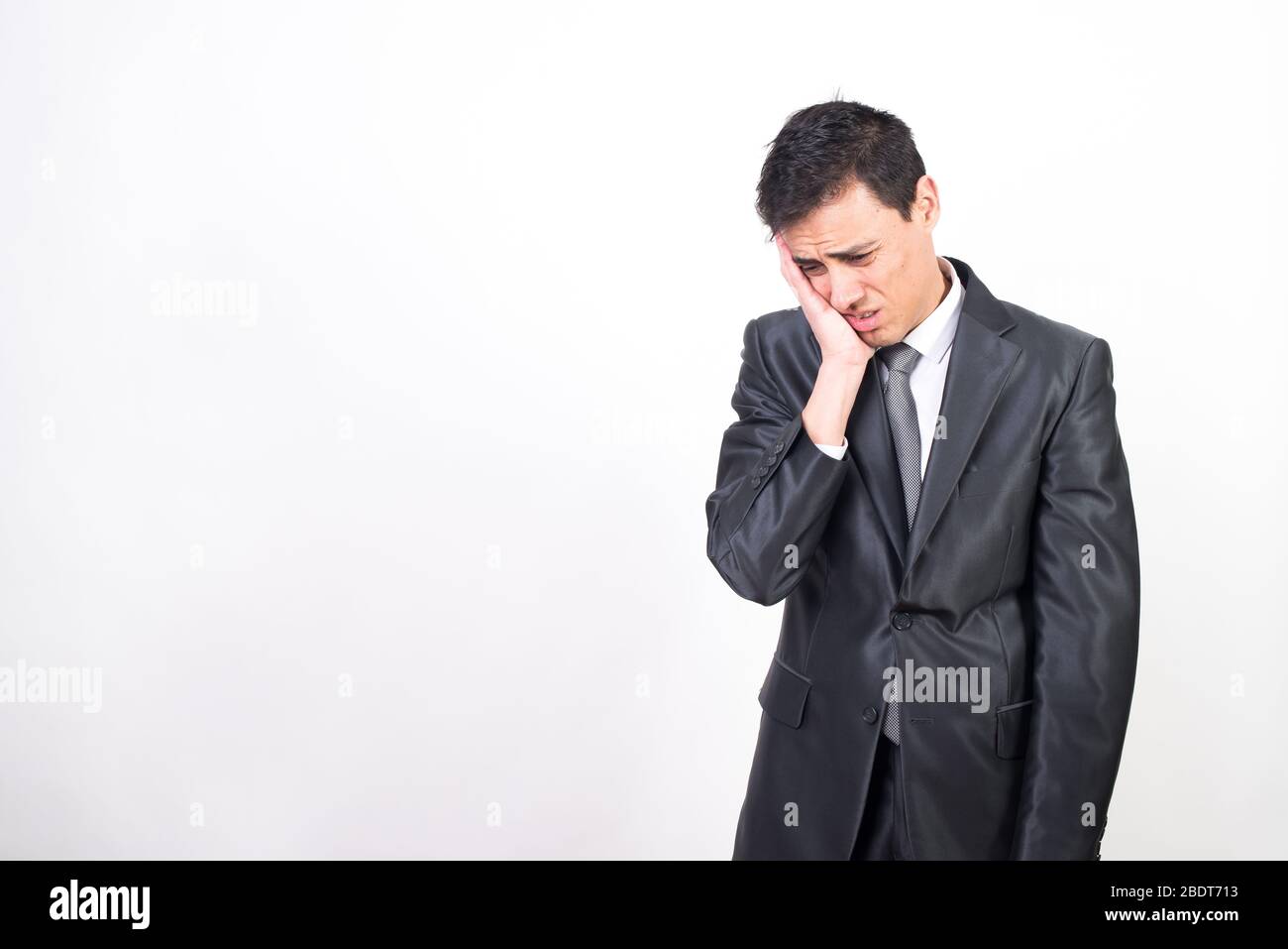 Crying man in suit. white background, medium shot Stock Photo - Alamy