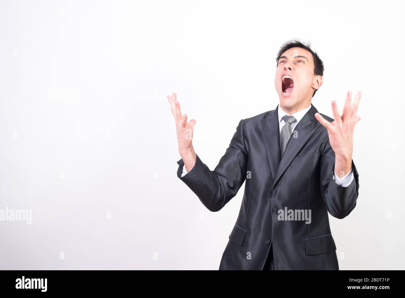 Hysterical man in suit. White background, medium shot Stock Photo - Alamy