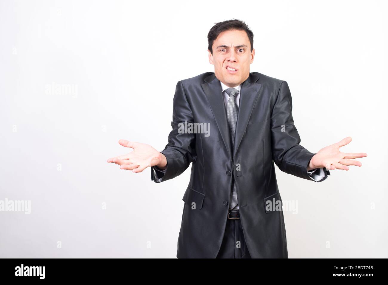 Doubting man in suit. White background, Medium shot Stock Photo - Alamy