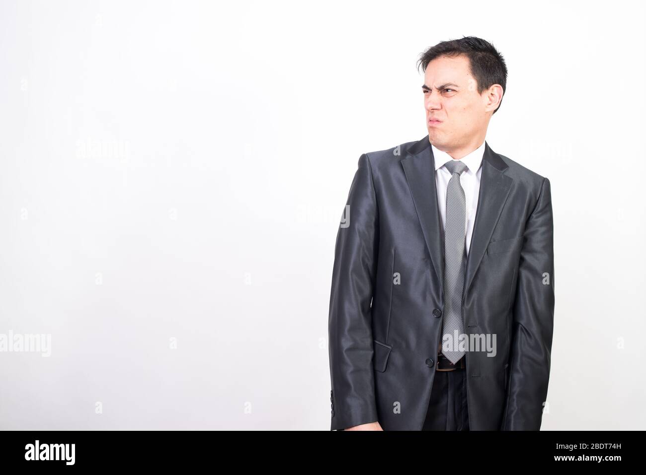 Doubting man in suit. White background, Medium shot Stock Photo - Alamy