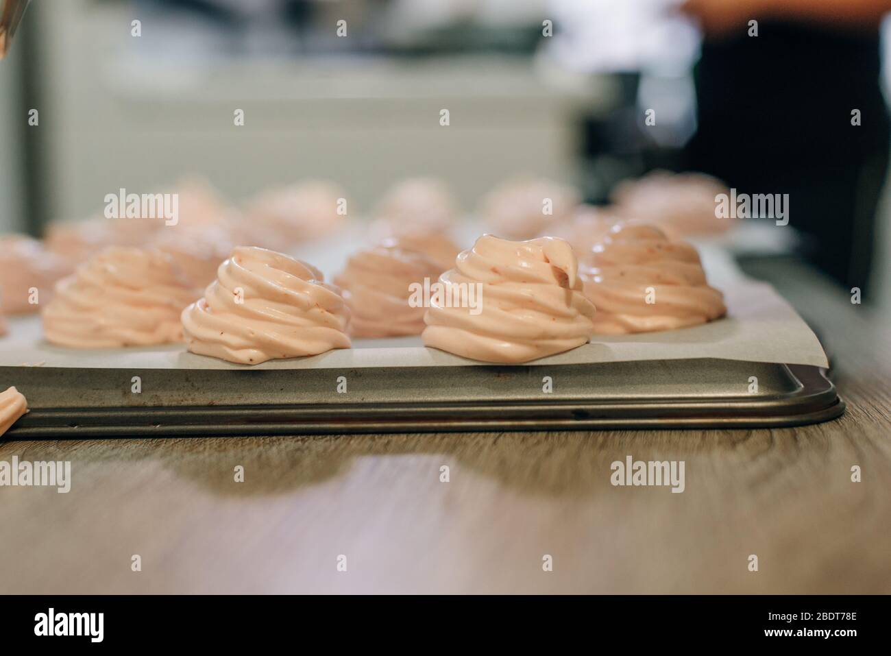 Homemade pink marshmallows on baking paper background on the kitchen ...