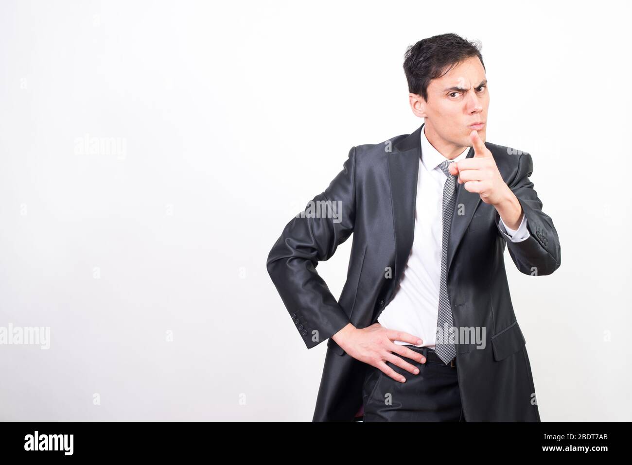 Man in suit scolding someone. White background, Medium shot Stock Photo ...