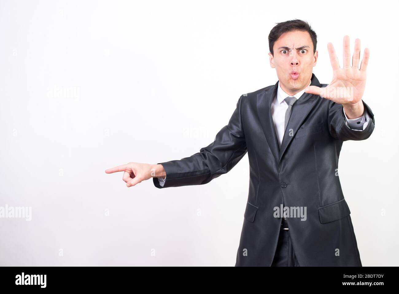 Surprised man in suit pointing to copy space. White background, Medium ...