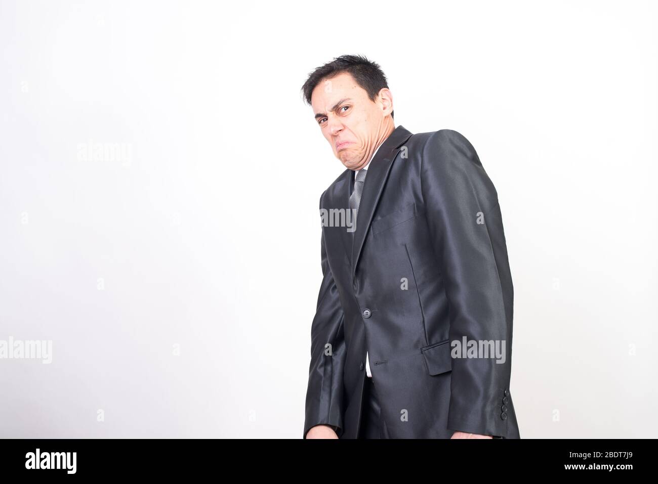 Disgusted man in suit retreating, on white background. Middle plane ...