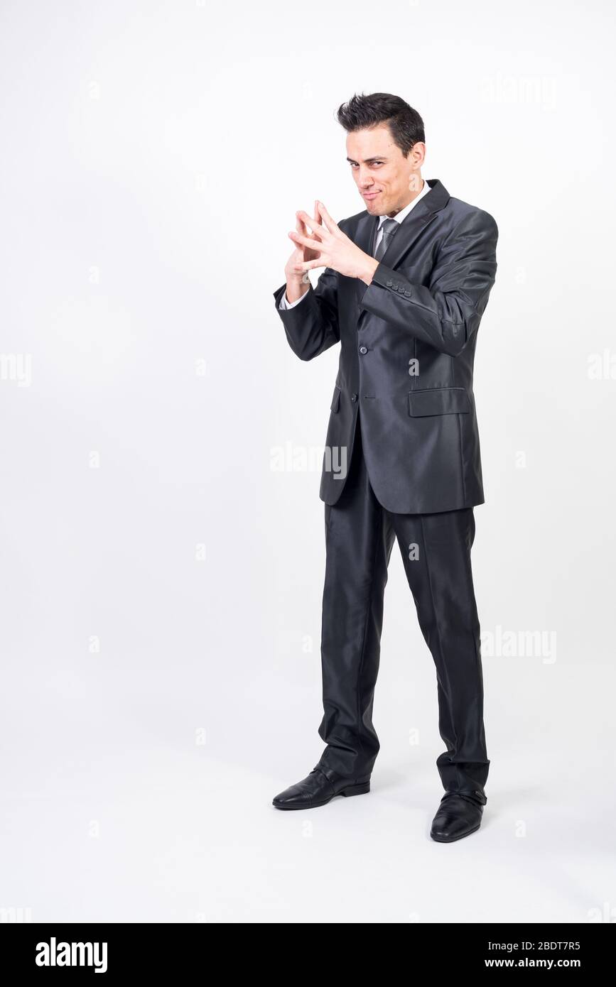 Evil man in suit machining a devilish plan. Full body, white background ...