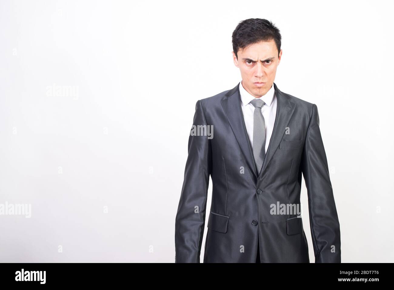 Challenging man in suit. White background. Middle plane Stock Photo - Alamy