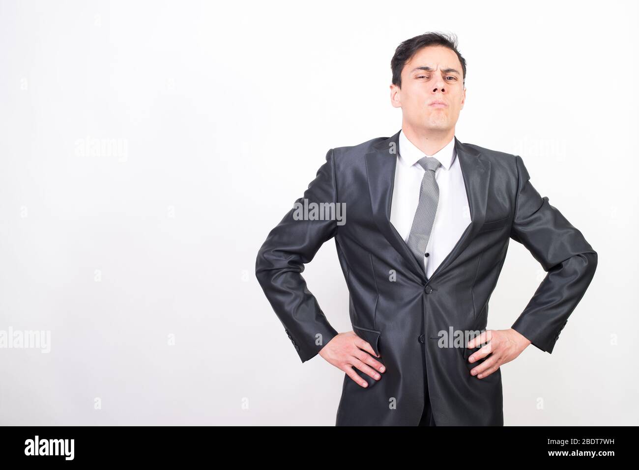 Distrustful man in suit. White background. Middle plane Stock Photo - Alamy