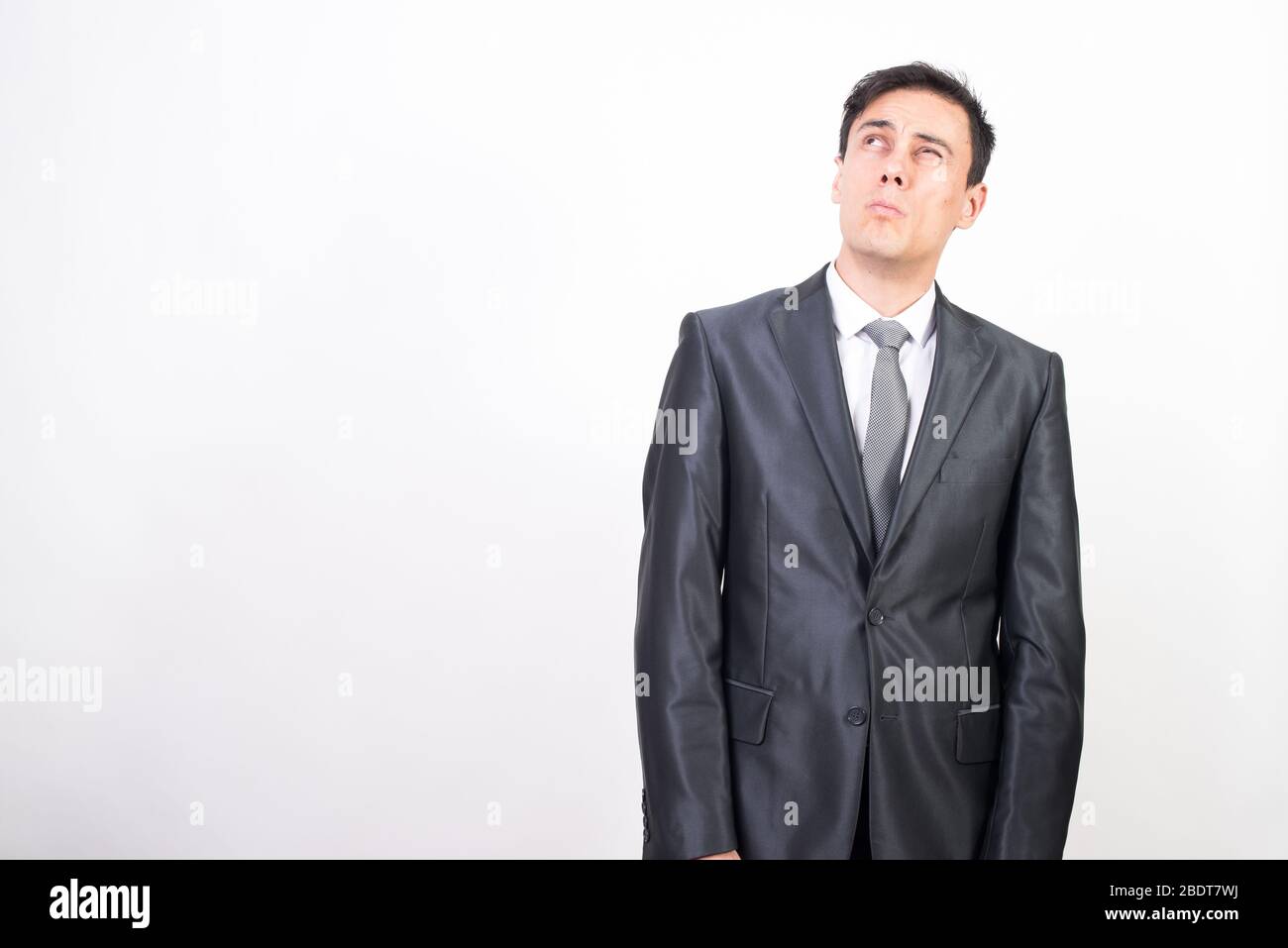 Distrustful man in suit. White background. Middle plane Stock Photo - Alamy