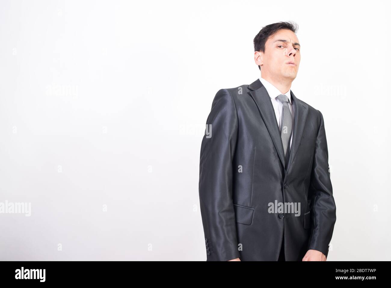 Distrustful man in suit. White background. Middle plane Stock Photo - Alamy