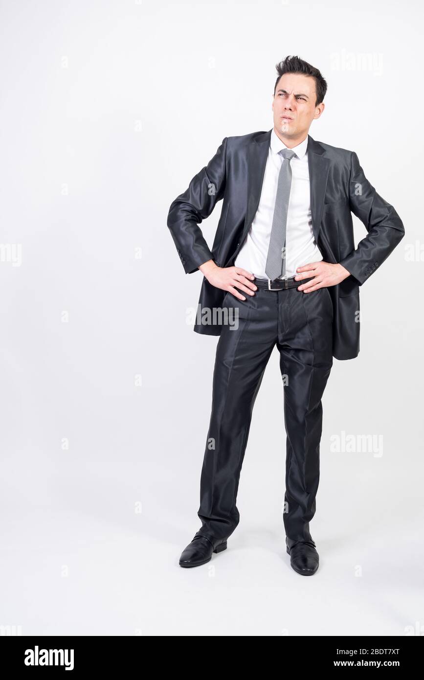 Doubting man in suit. White background, full body Stock Photo - Alamy