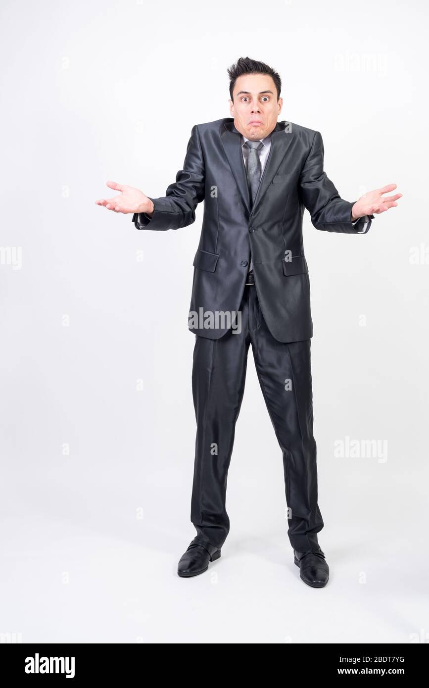 Doubting man in suit. White background, full body Stock Photo - Alamy