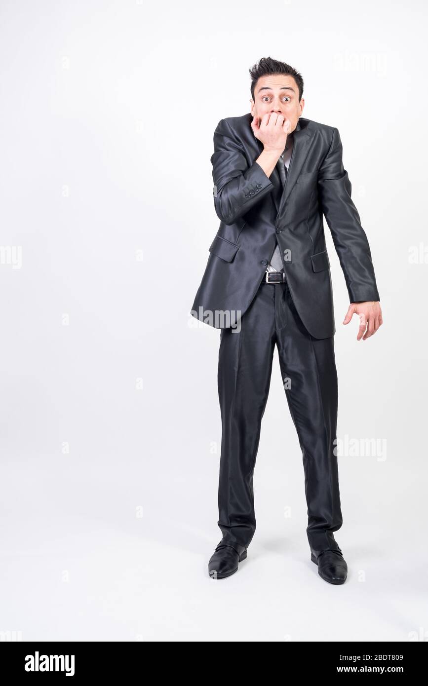 Nervous man in suit eating his nails. white background, full body Stock ...
