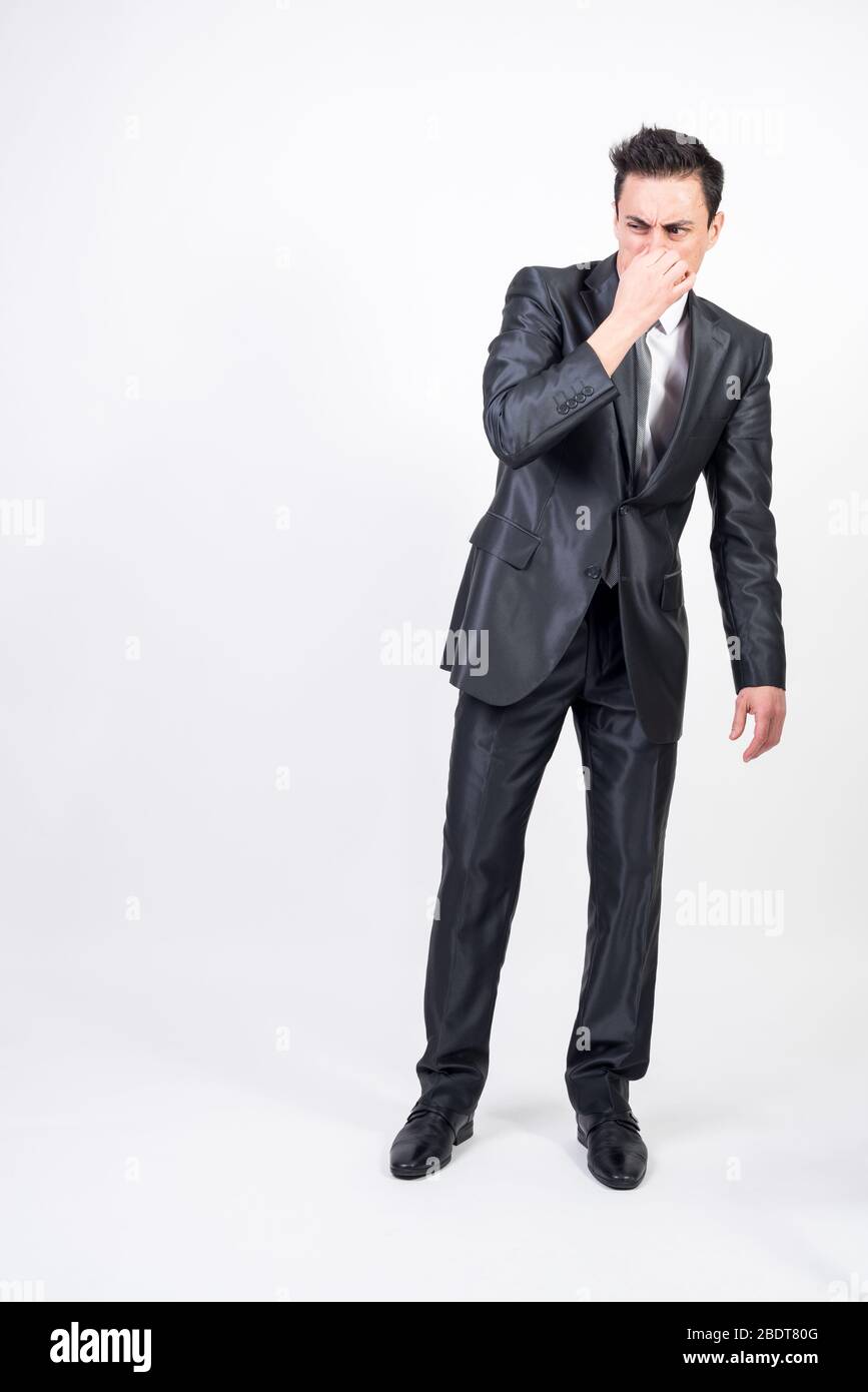 Man in suit disgusted by bad smell. White background, full body Stock ...