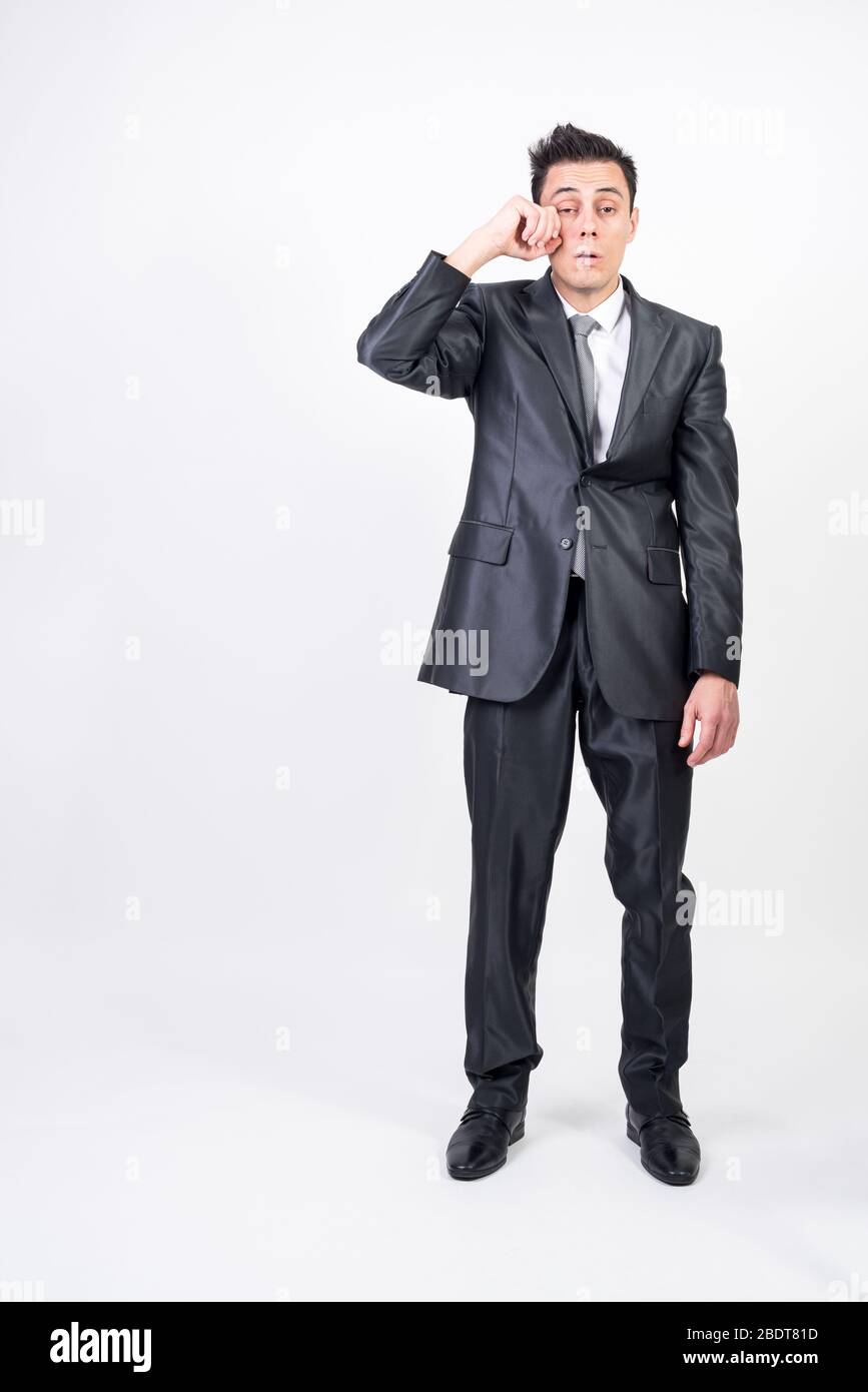 Sleepy man in suit. White background, full body Stock Photo - Alamy
