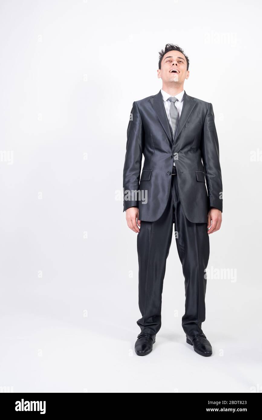 Man in suit feeling pleasure. White background, full body Stock Photo ...