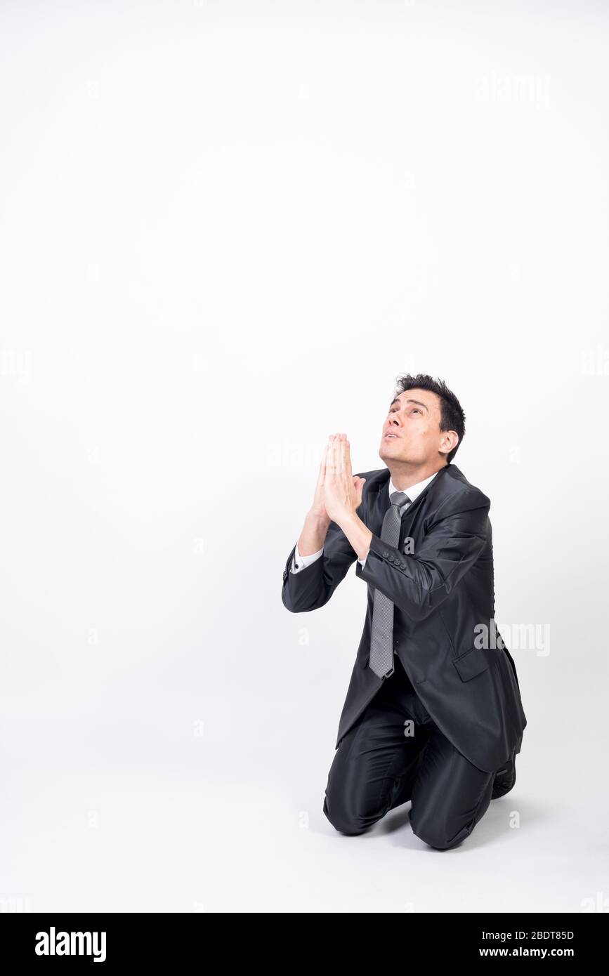 Man in suit praying. White background, full body Stock Photo - Alamy