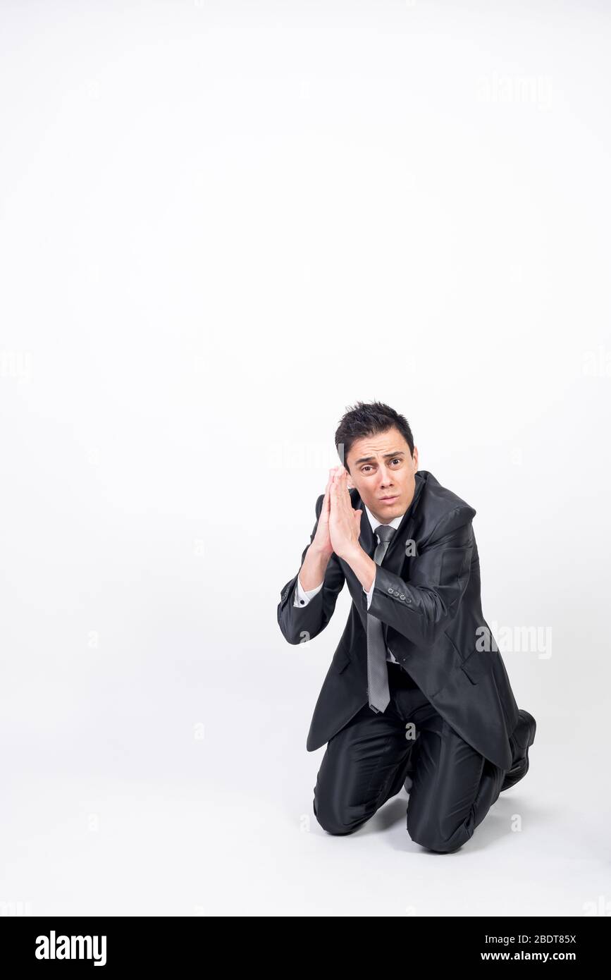 Man in suit begging. White background, full body Stock Photo - Alamy
