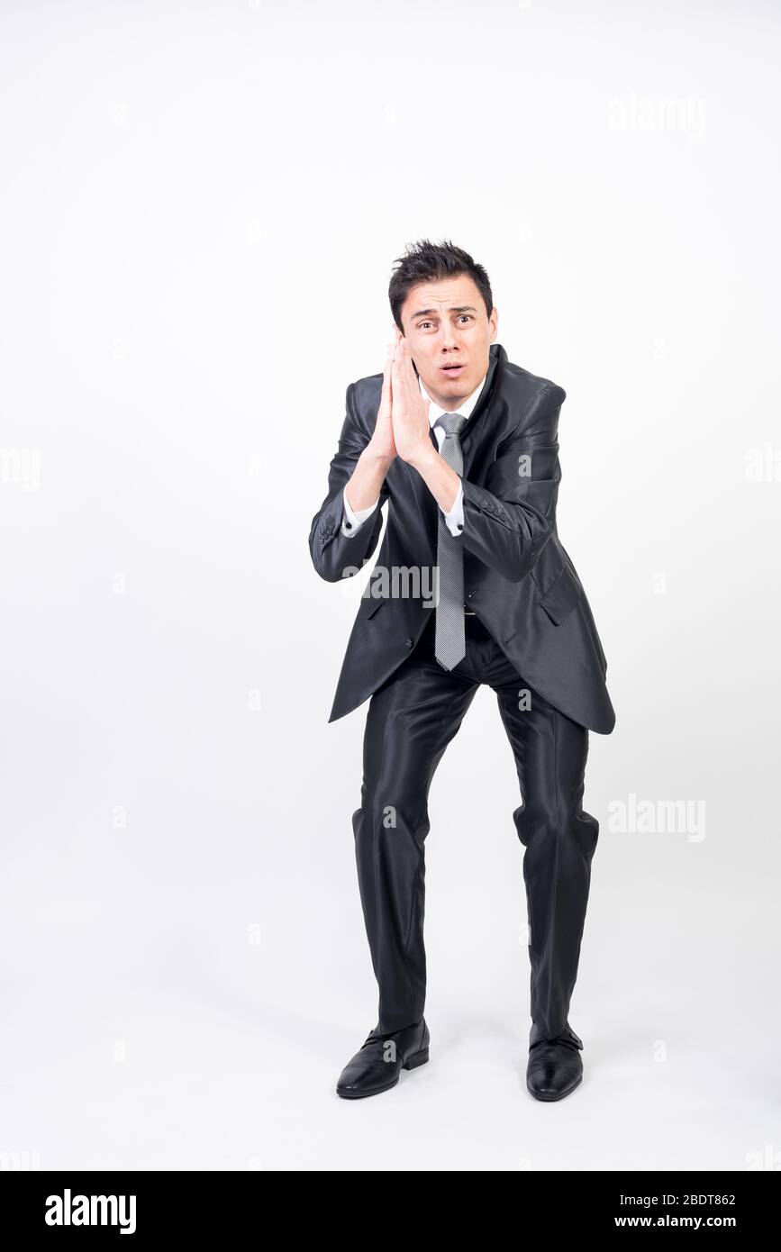 Man in suit begging. White background, full body Stock Photo - Alamy