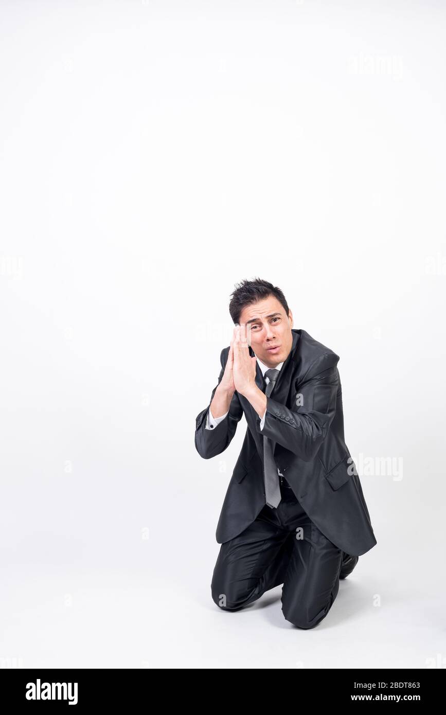 Man in suit begging. White background, full body Stock Photo - Alamy