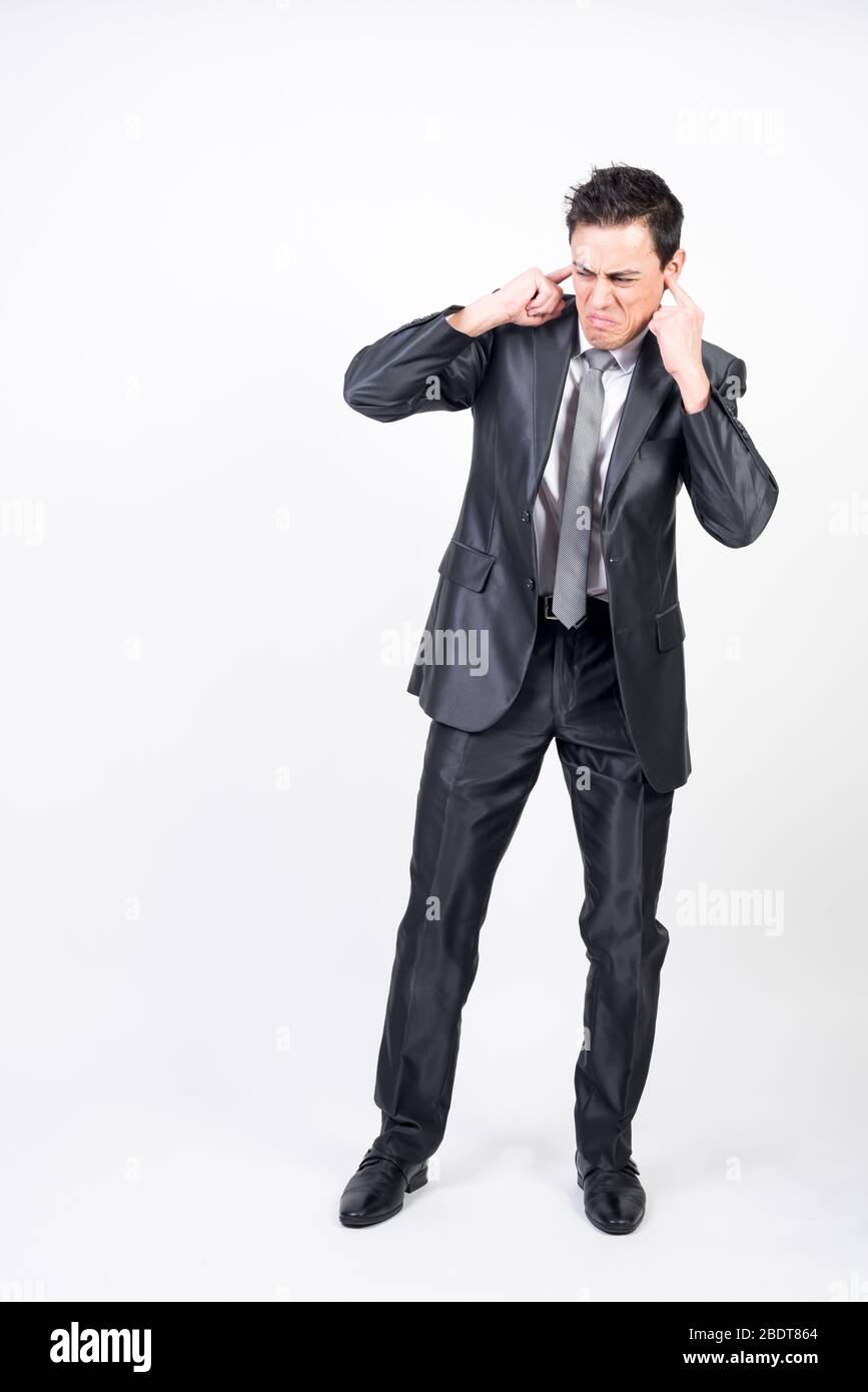 Man in suit disgusted by noise. White background, full body Stock Photo ...