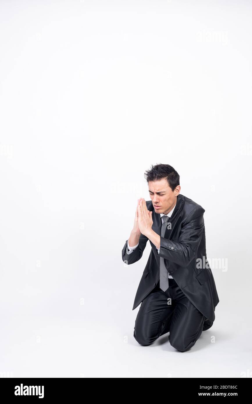 Man in suit praying. White background, full body Stock Photo - Alamy