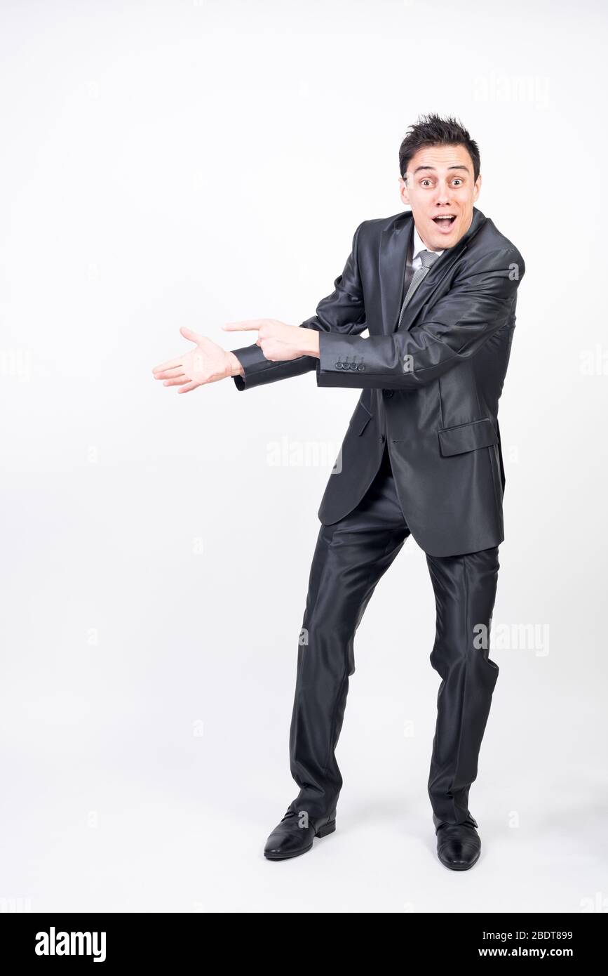 Surprised man in suit pointing to copy space. White background, full ...